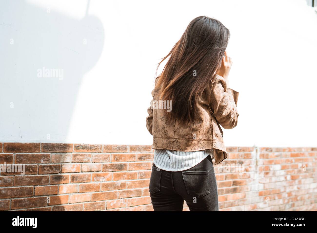 Asian woman walking behind street hi-res stock photography and images ...