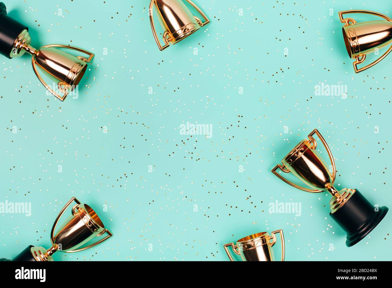 Frame made of winner cups on a pastel blue background with copy space ...