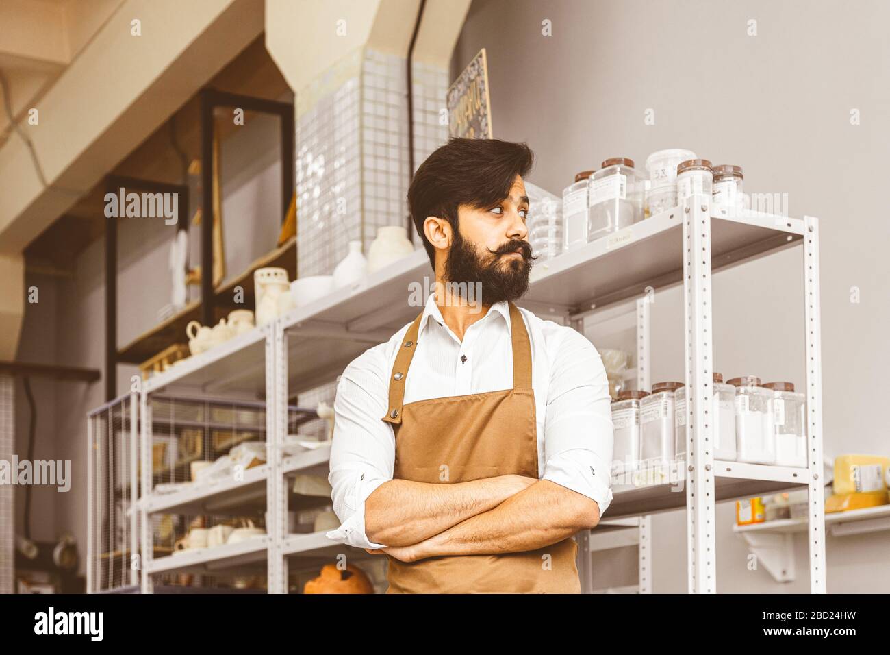 Portrait of a young attractive businessman craftsman with a beard and ...