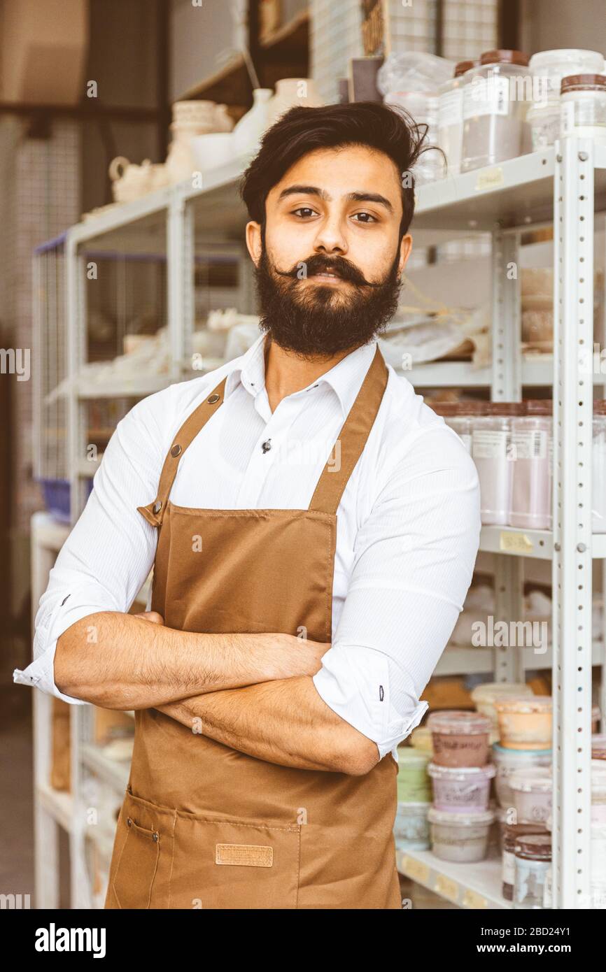 Portrait of a young attractive businessman craftsman with a beard and ...