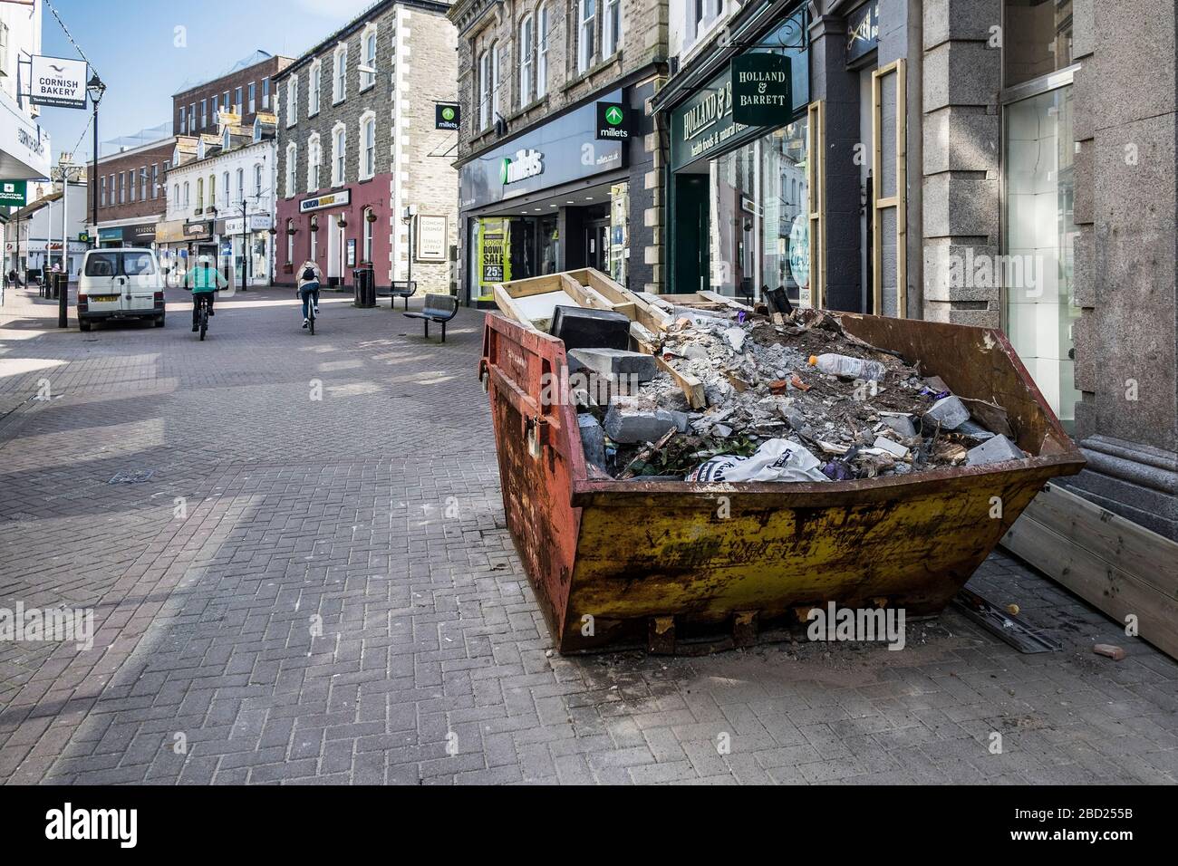 A building skip full of rubble in a street in Newquay Town centre in ...
