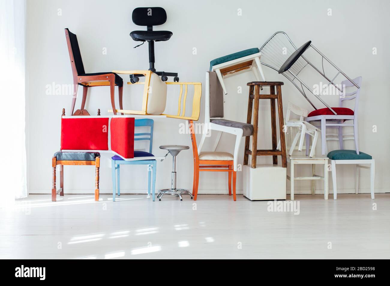 lots of different chairs in the interior of an empty white room Stock ...