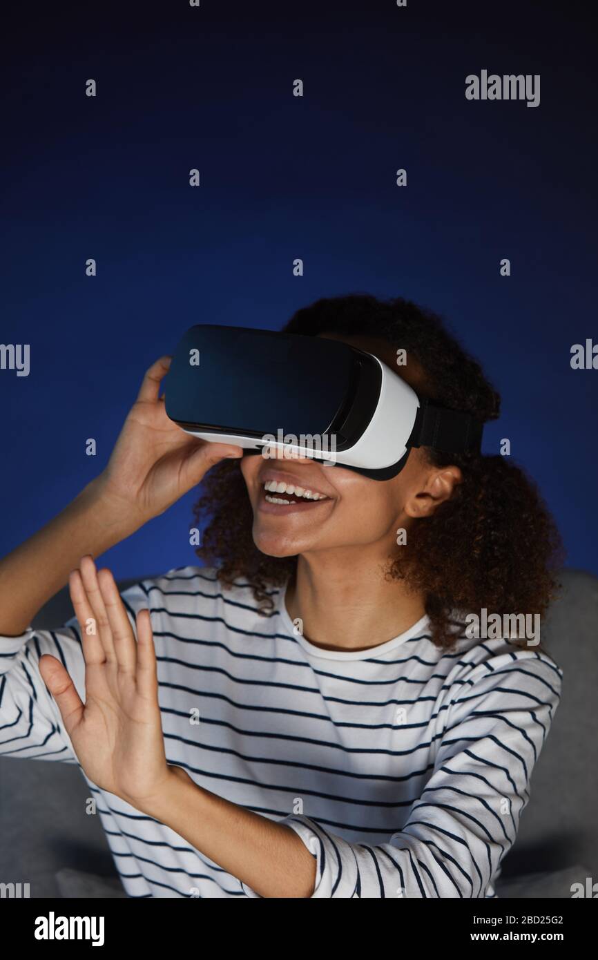Vertical portrait of young African-American woman wearing virtual ...
