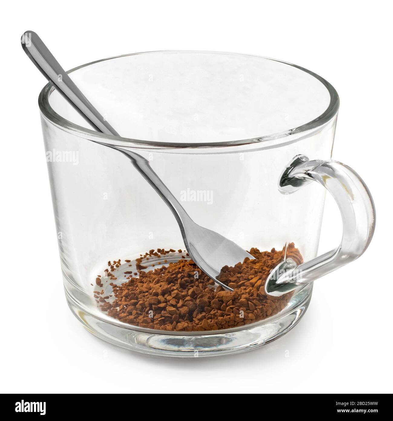 Dry instant coffee in a glass mug with metal spoon isolated on white ...