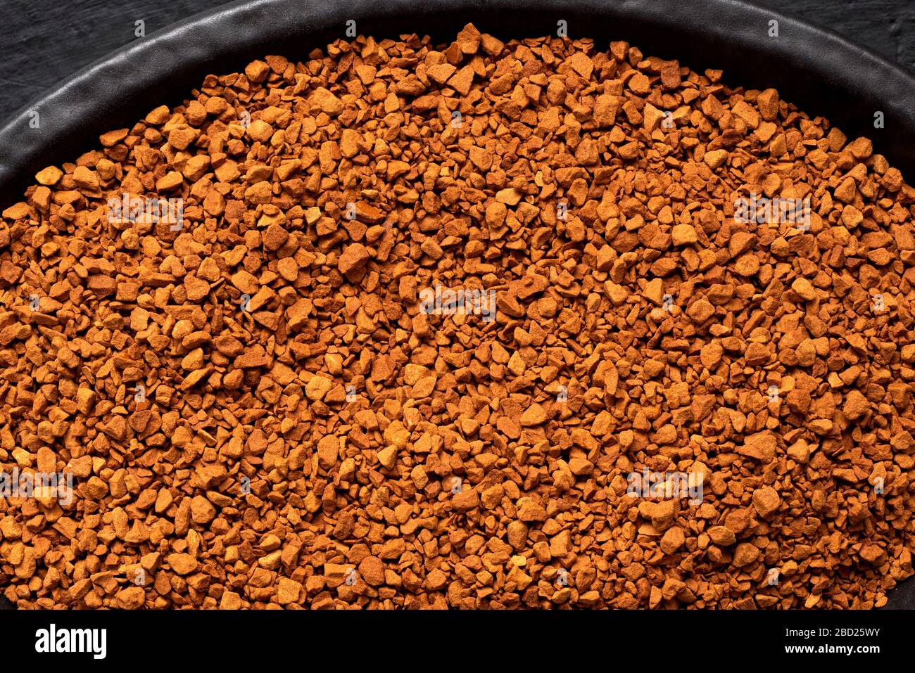 Detail of dry instant coffee in a black ceramic dish Stock Photo - Alamy
