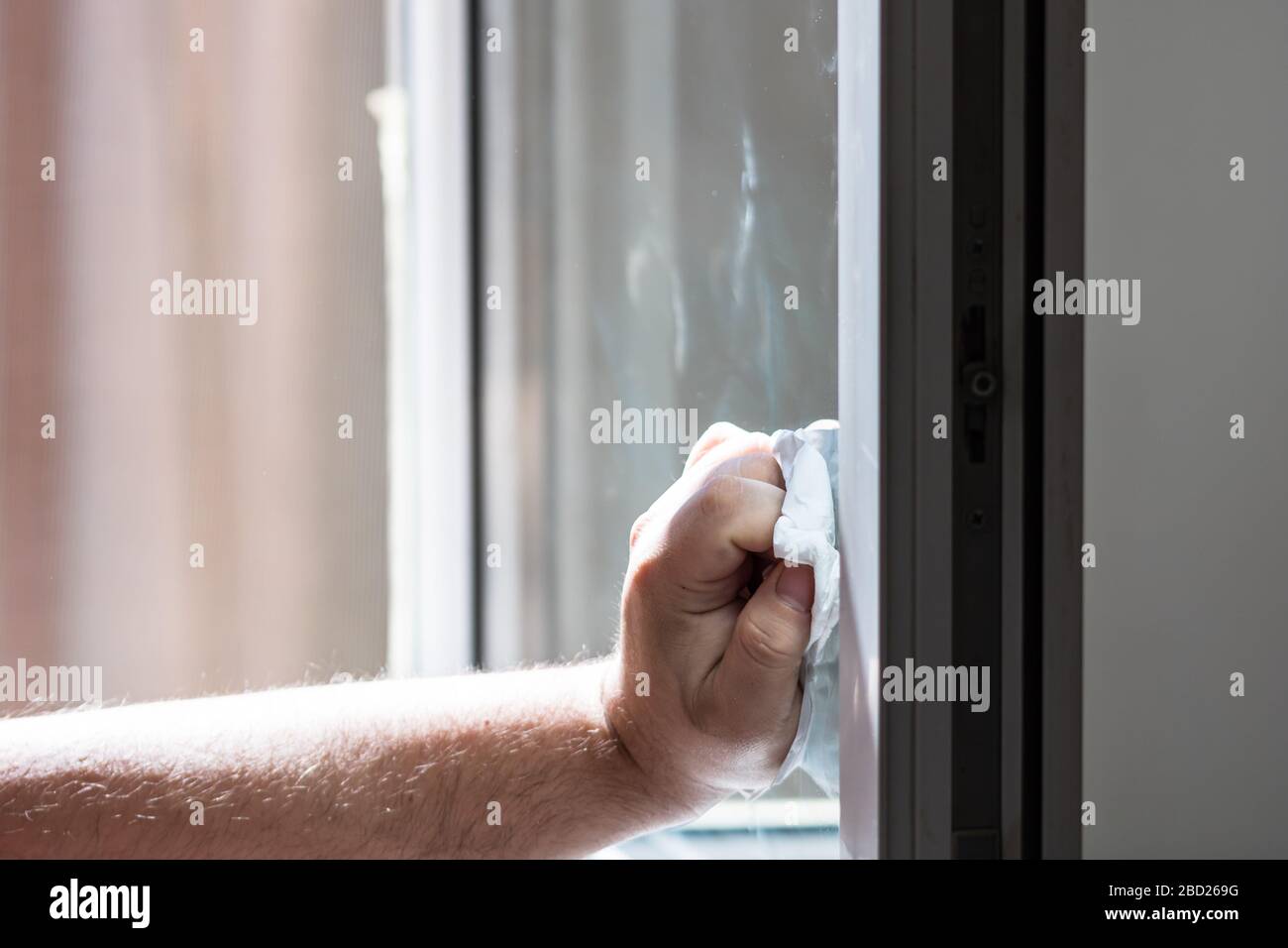 Man wiping window using paper towels, cleaning services concept ...