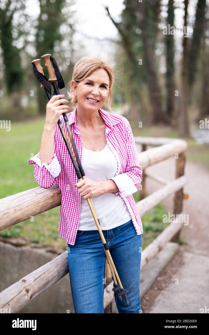 An attractive woman with a sympathetic laugh in nature while walking ...