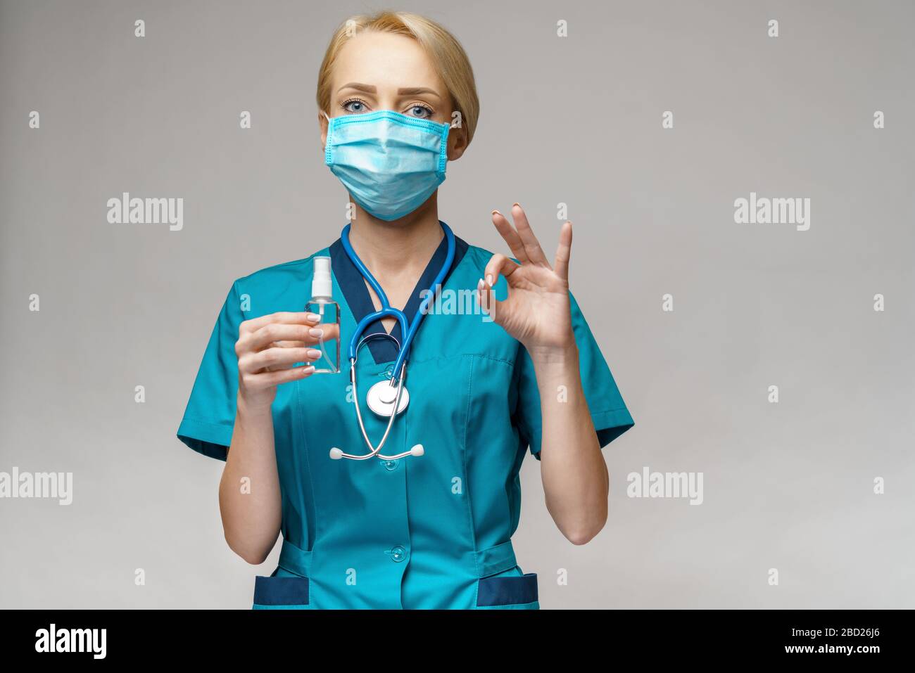 medical doctor nurse wearing protective mask - holding bottle of ...