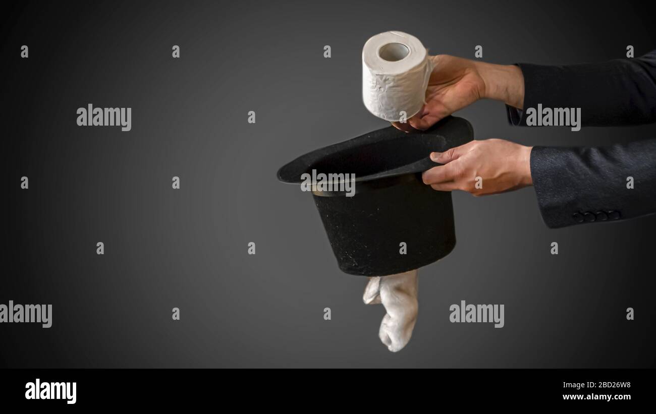 Man is taking a toilet paper from a hat like a wizard. Concept photo of ...