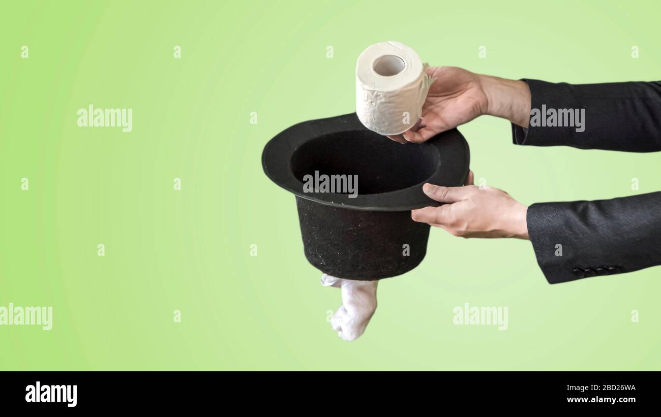 Man is taking a toilet paper from a hat like a wizard. Concept photo of ...