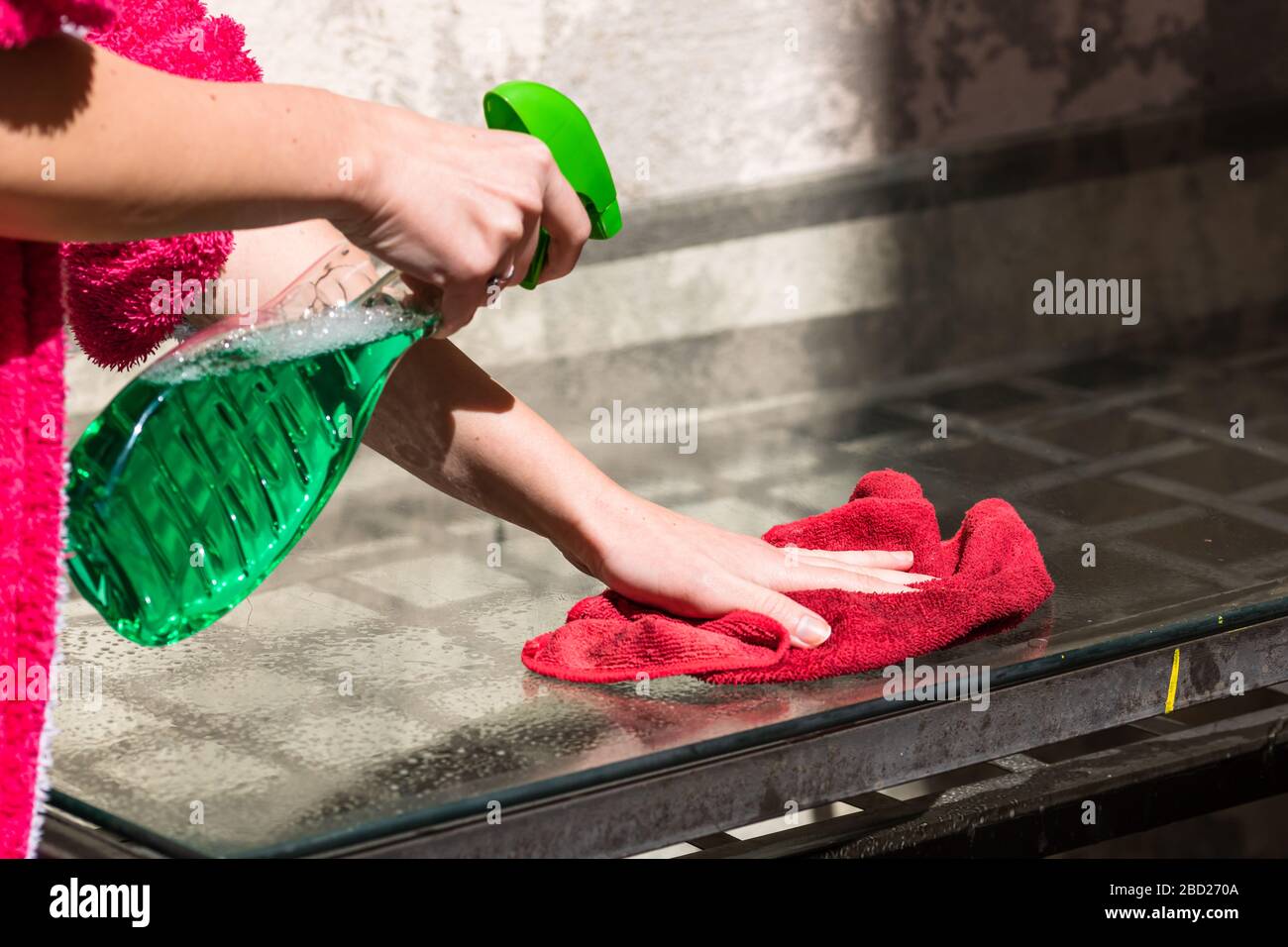 Woman cleaning glass table hi-res stock photography and images - Alamy