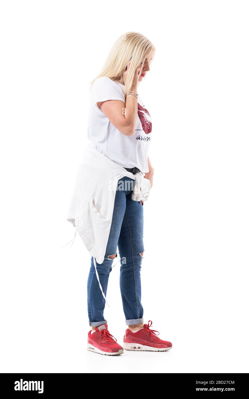 Side view of serious concerned mid age woman listening bad news on cell ...