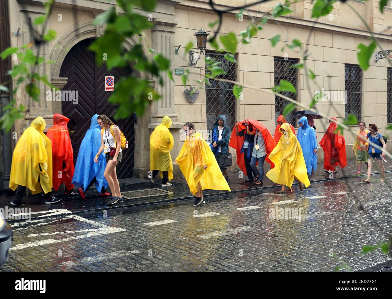 Cracow. Krakow. Poland. Young people wearing colorfull plastic ponchos ...