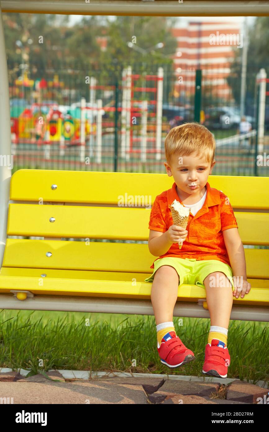 outdoor portrait of a little boy. child eating ice cream Stock Photo ...