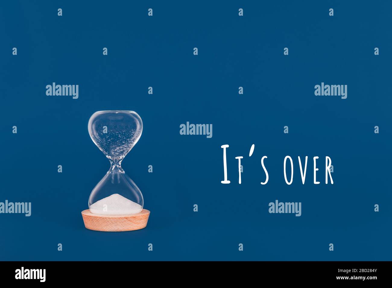 Hourglass with the finished sand with It's over wording. Concept of ...