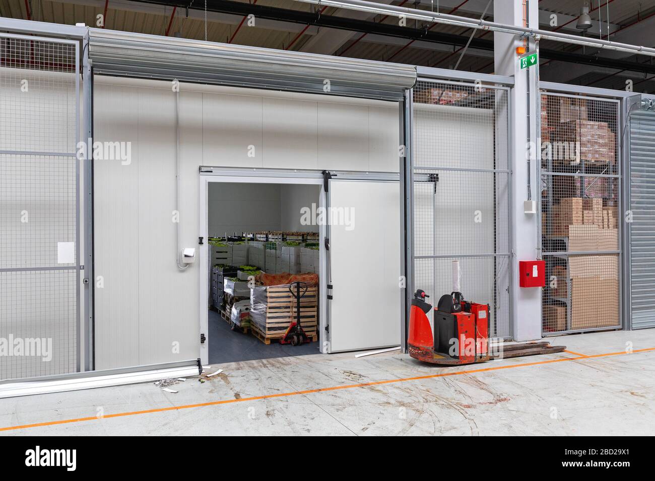 Pallet Truck and Cargo Door in Distribution Warehouse Stock Photo - Alamy