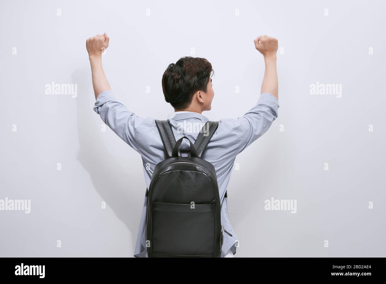 Portrait of victorious man looking up while standing on white ...