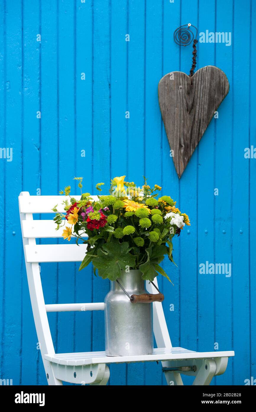 Colorful flower bouquet in a milk jug Stock Photo - Alamy