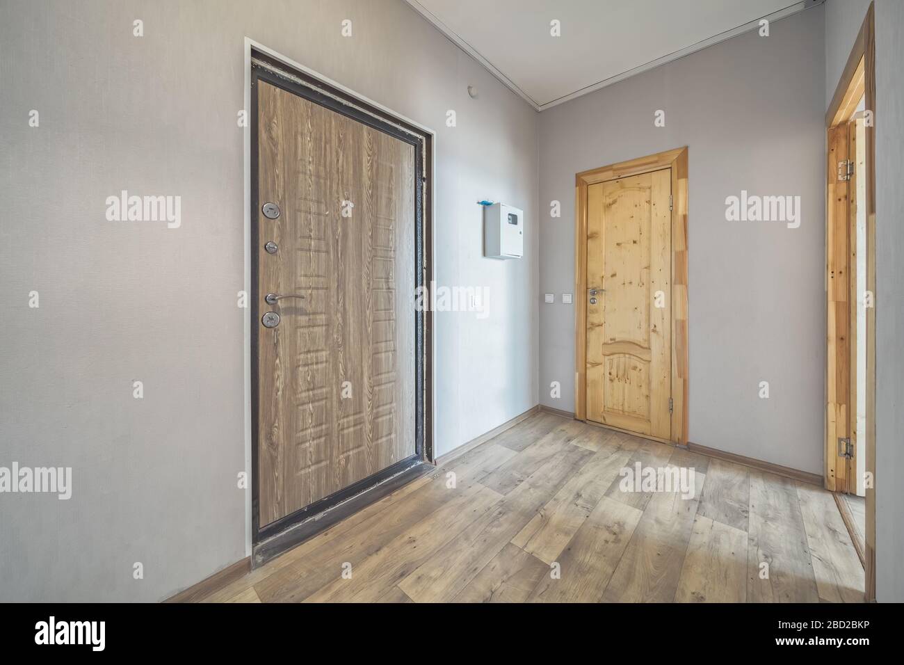 Empty residential house entrance with closed wooden doors tiny hallway ...