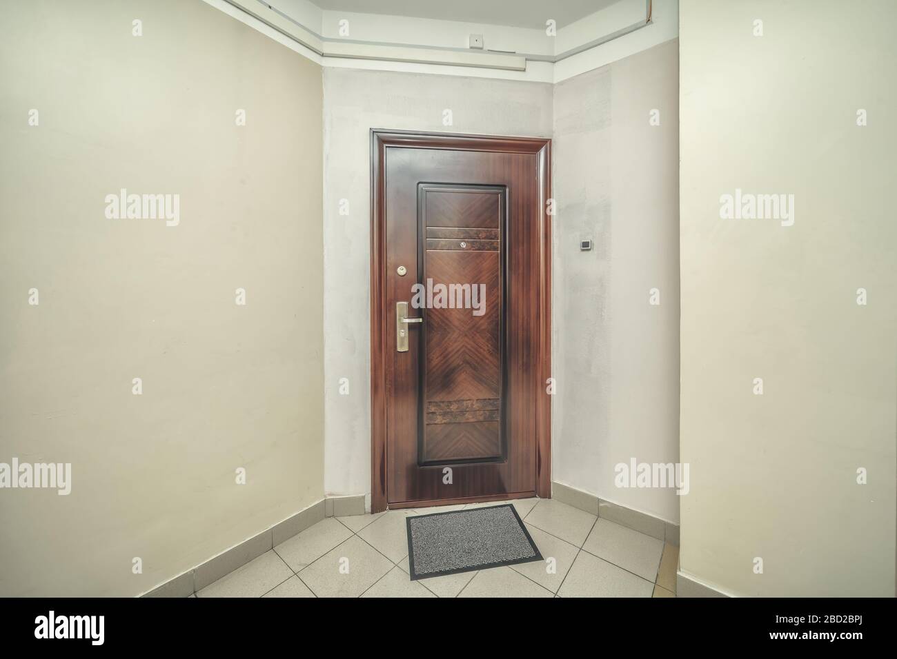 Empty residential house entrance with closed wooden doors tiny hallway ...