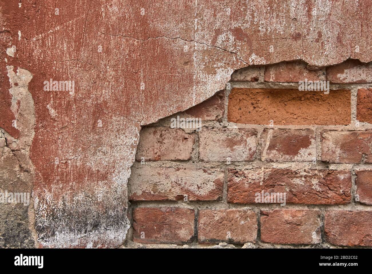 the old plaster on the brick wall is falling off Stock Photo - Alamy