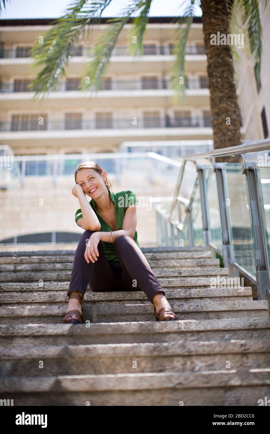 A woman sitting on steps Stock Photo - Alamy