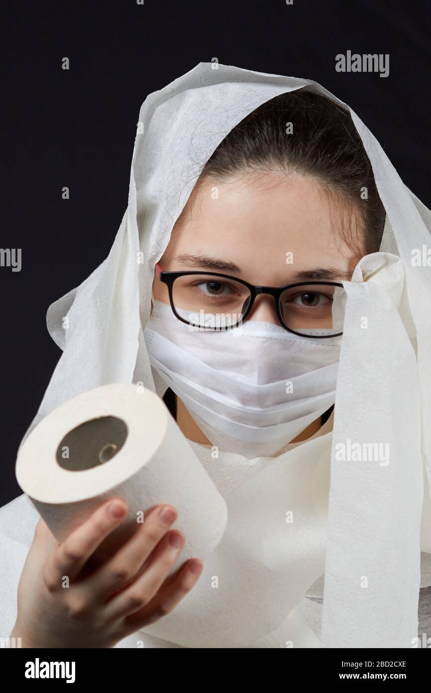 a greedy young person with glasses and a mask wrapped in toilet rolls ...