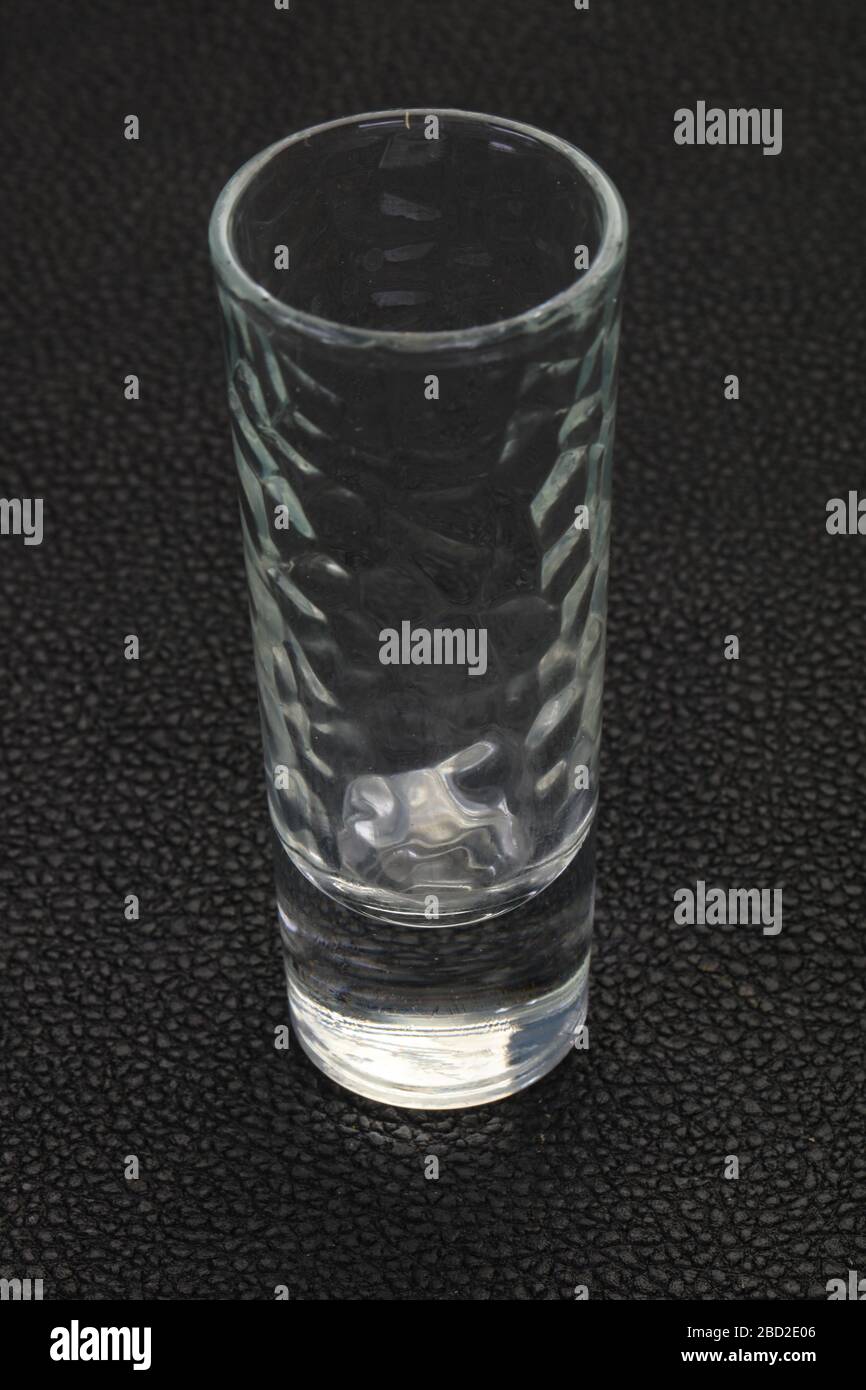 Empty glass cup over black background Stock Photo - Alamy