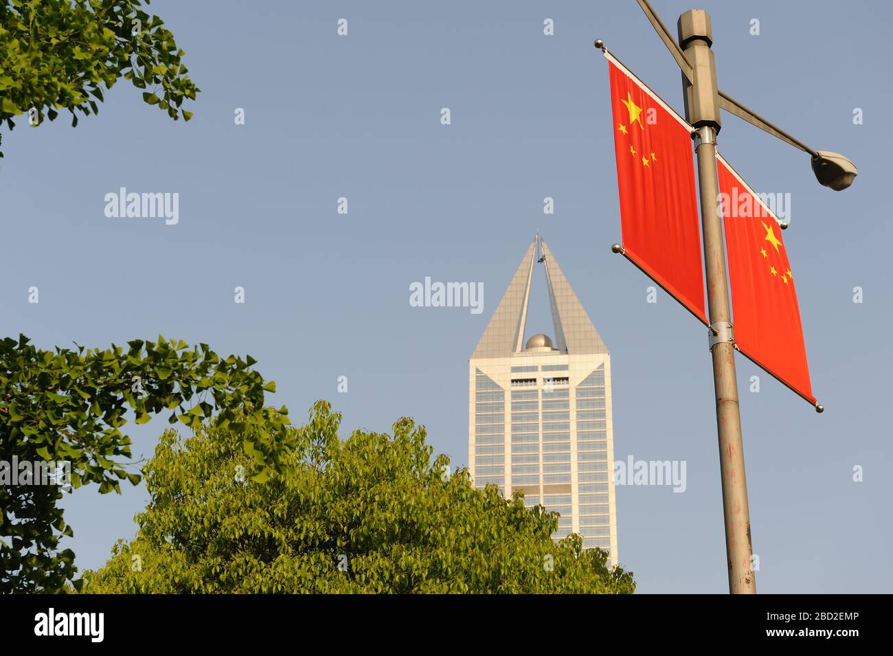 Chinese flag at People's Square, most famous place in Shanghai. Early ...