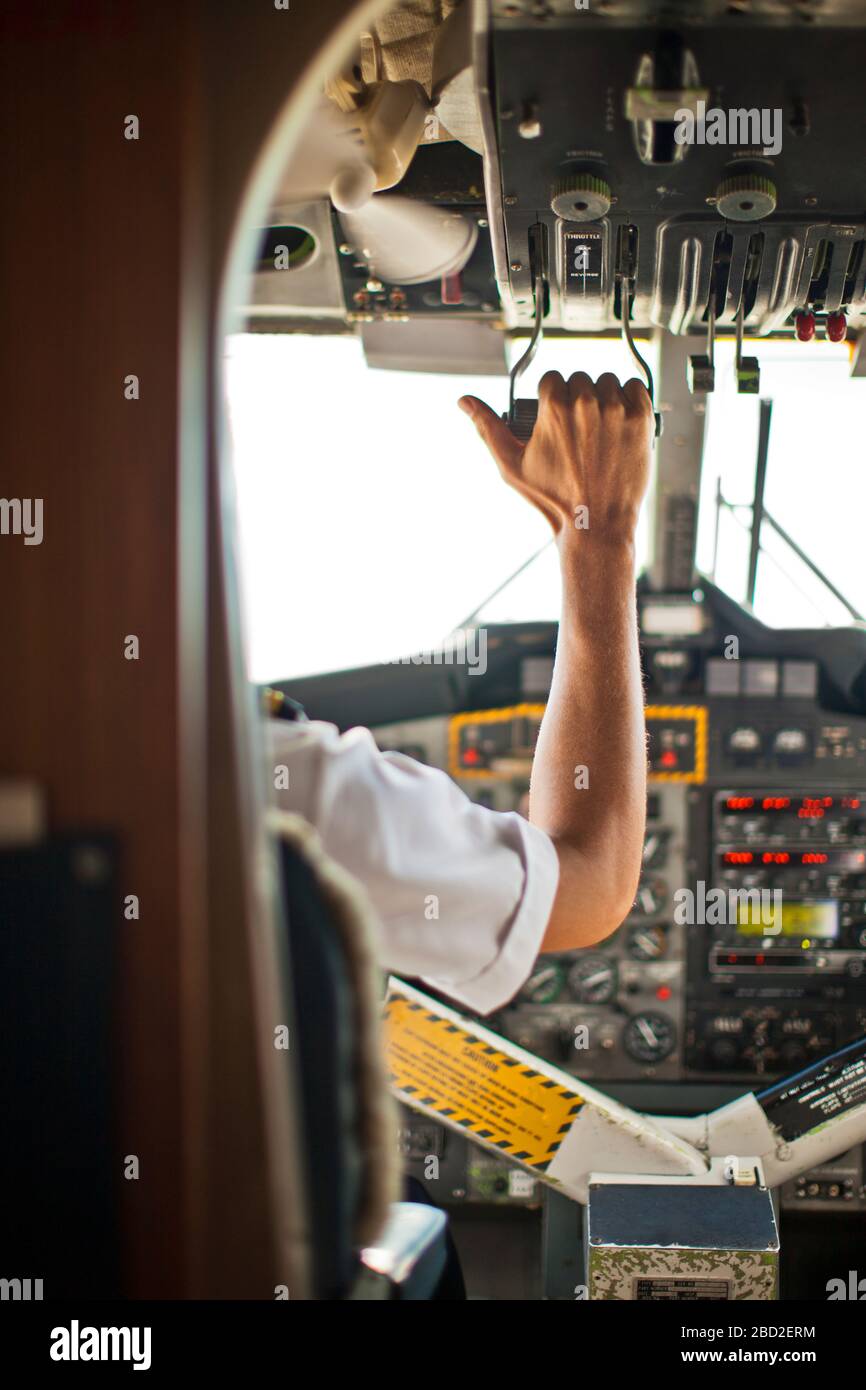 Pilot pulls a handle in the cockpit of an airplane Stock Photo - Alamy