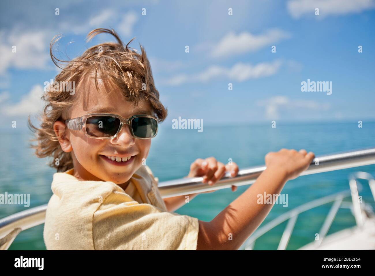 Portrait of a smiling young boy on a boat Stock Photo - Alamy