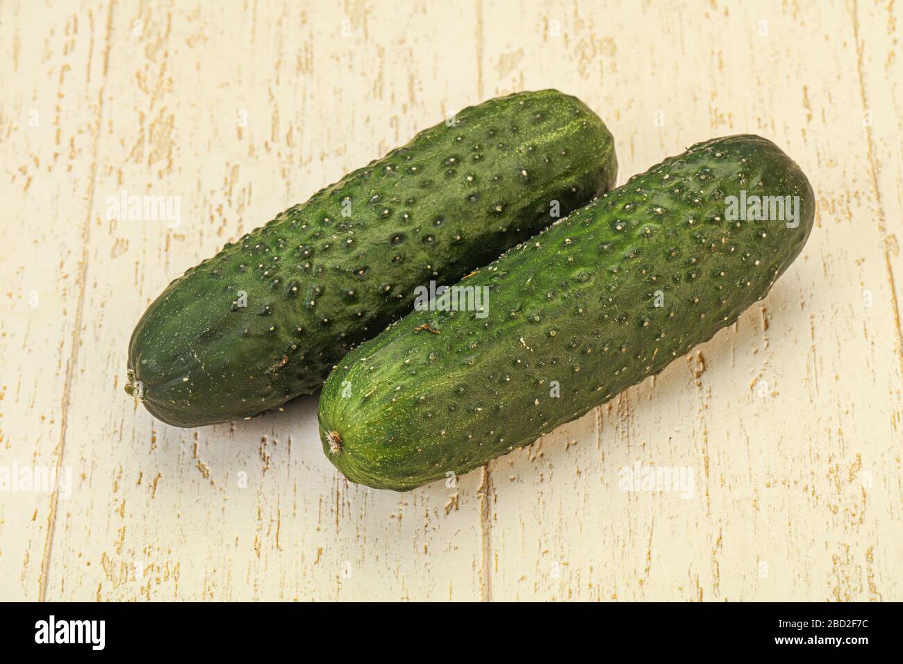 Green fresh two cucumbers over background Stock Photo - Alamy