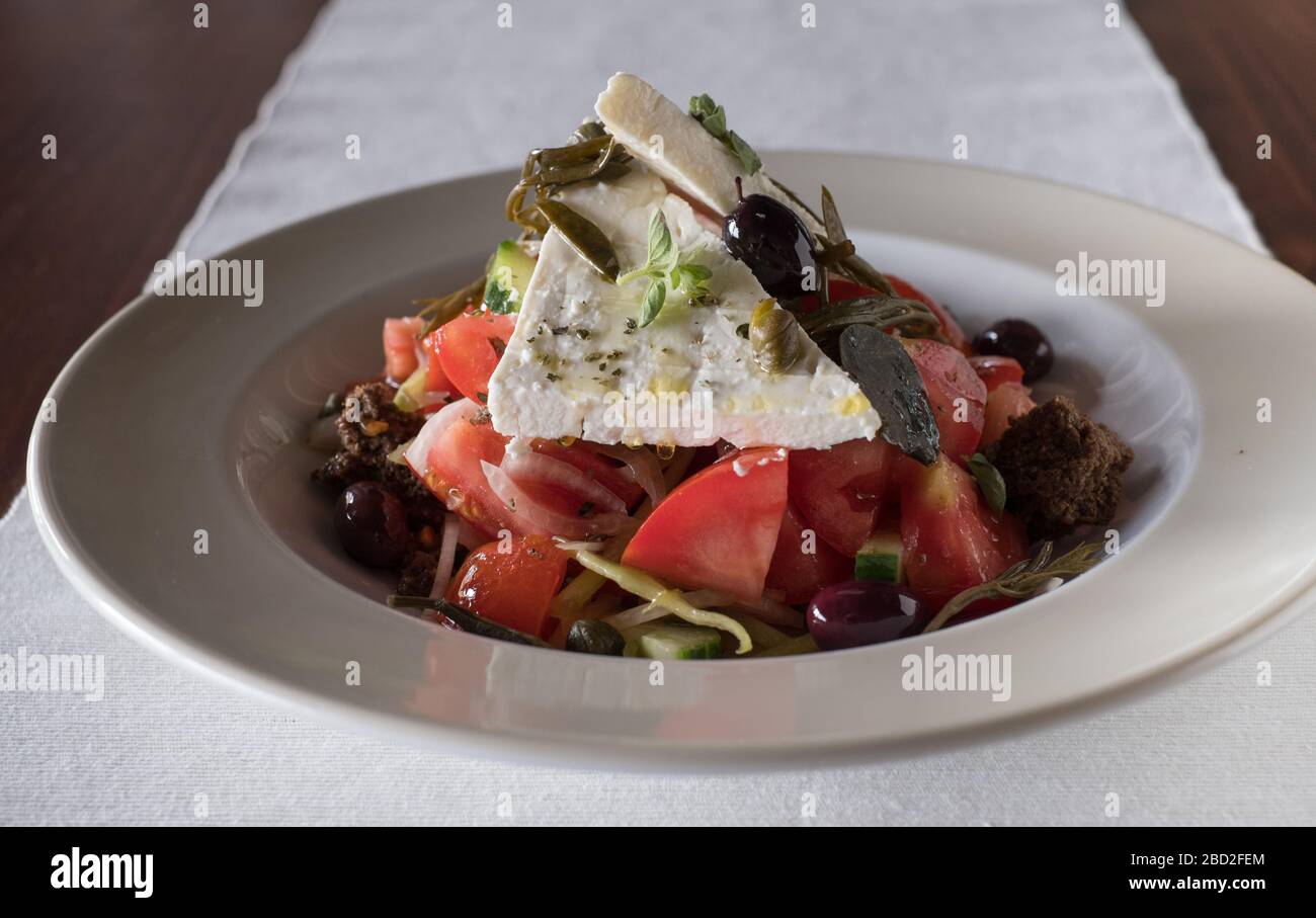 Traditional Greek salad with barrel feta cheese, capers and rock ...