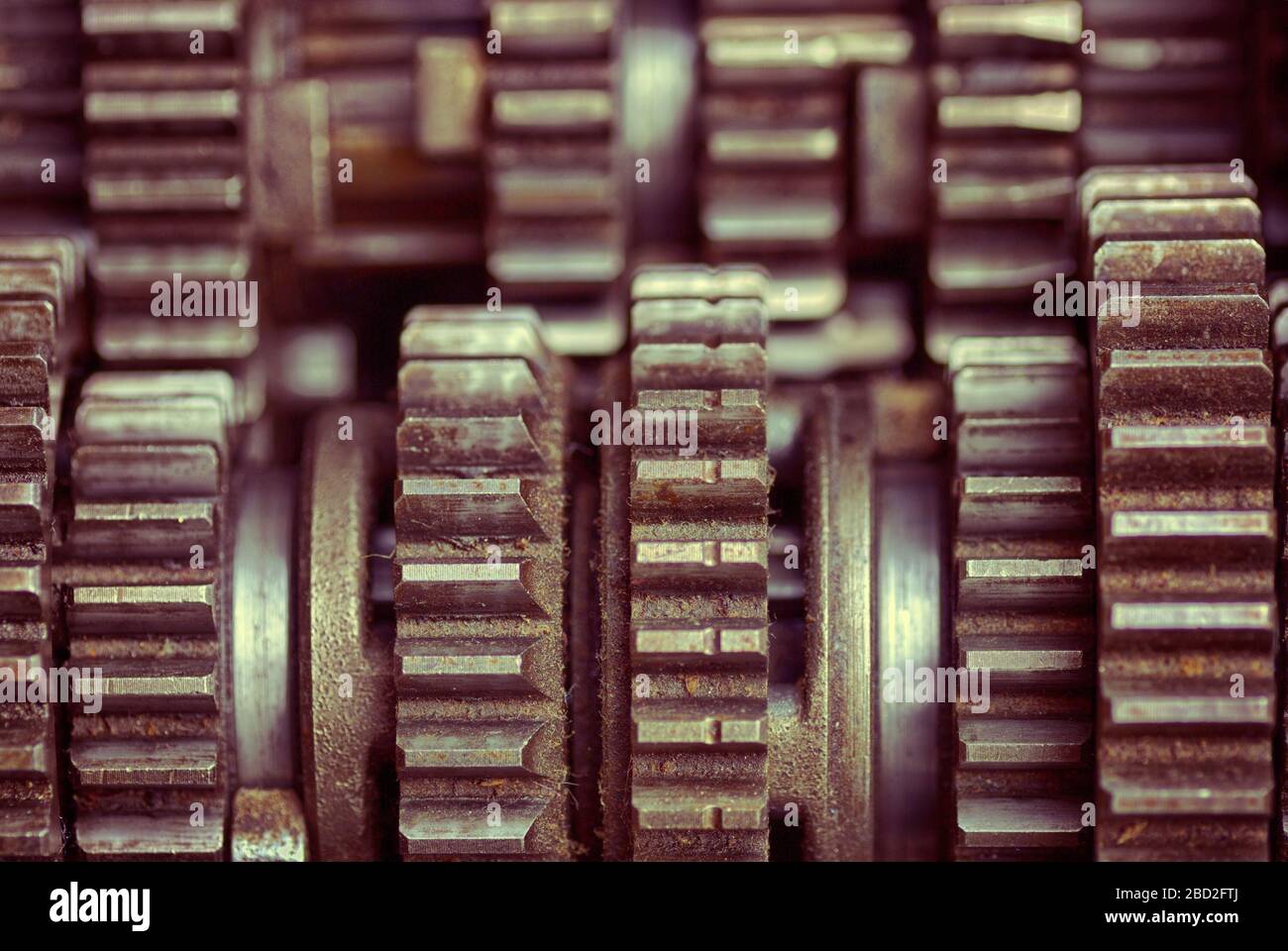 Inside view on old rusty gearbox with cogs and shafts, shallow depth of ...