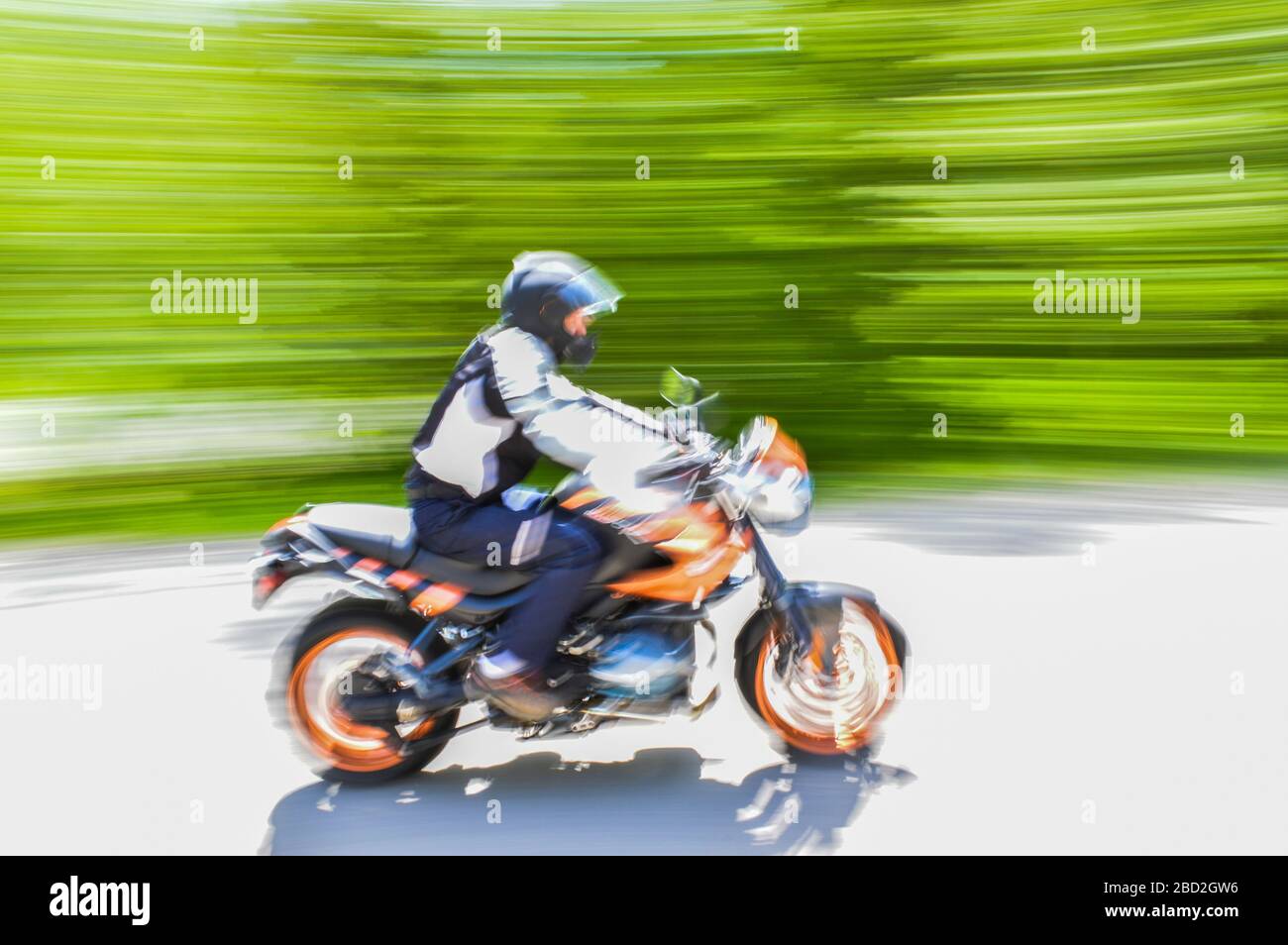 Young man going fast on a motorcycle, blur motion picture Stock Photo ...