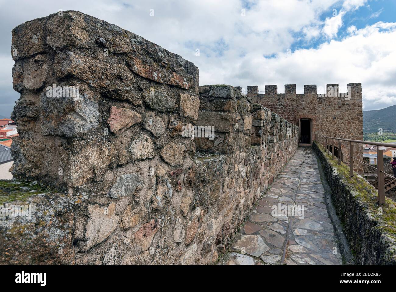 A stone walled corridor leading to a tower Stock Photo - Alamy
