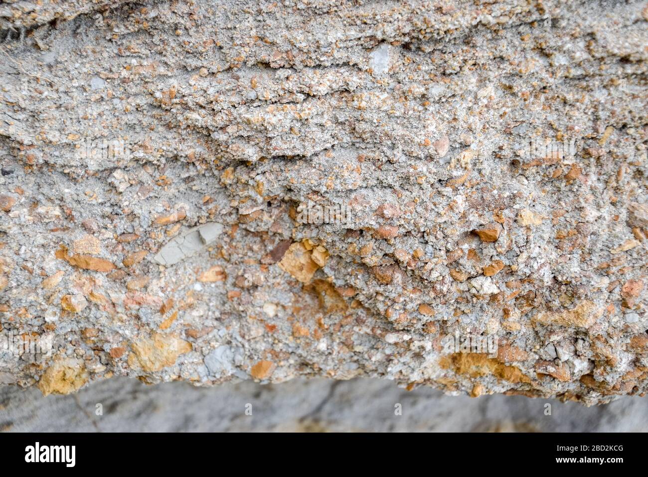 The sedimentary layers of the rock in the sand scree. sand, pebbles and ...