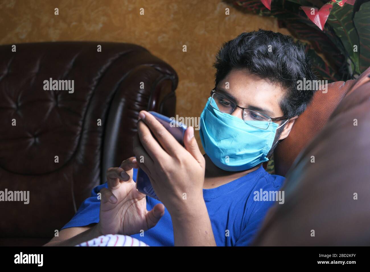 Man is wearing mask to prevent the infectious and using smart phone ...