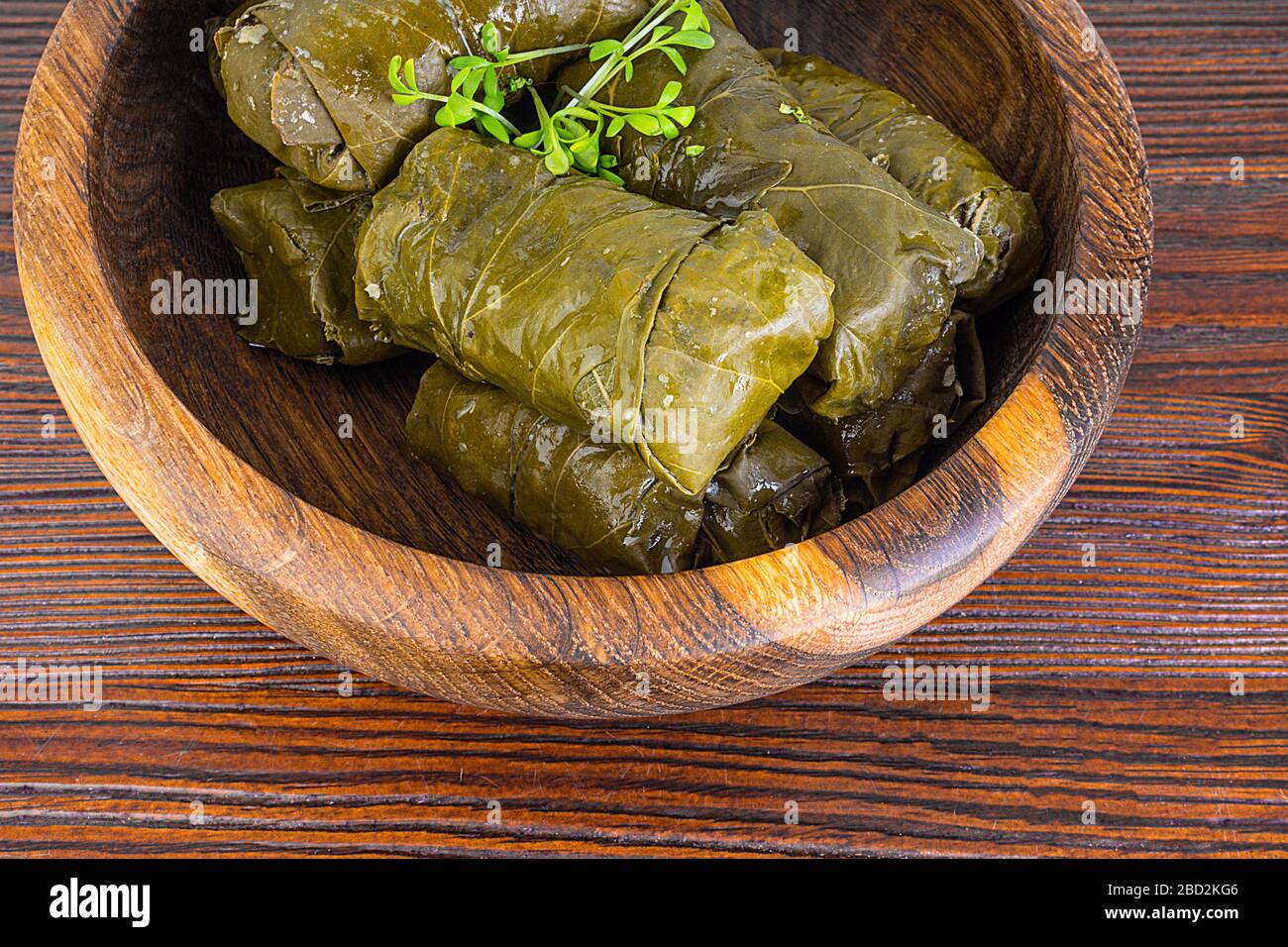 Traditional georgian dolma in grape leaves on wooden background Stock ...