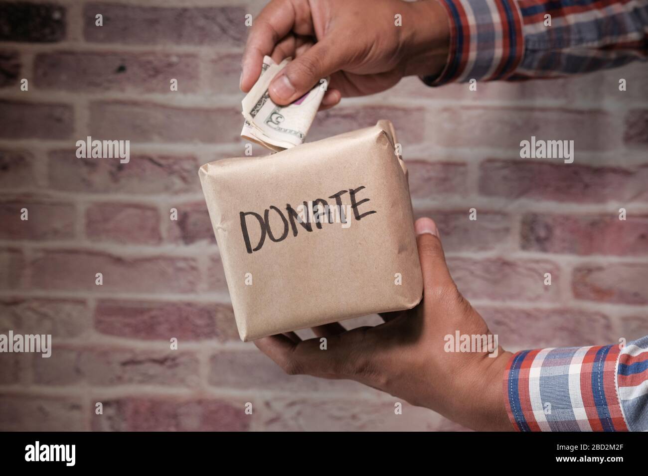 Donation Concept. man holding a Donate Box for Giving Stock Photo - Alamy