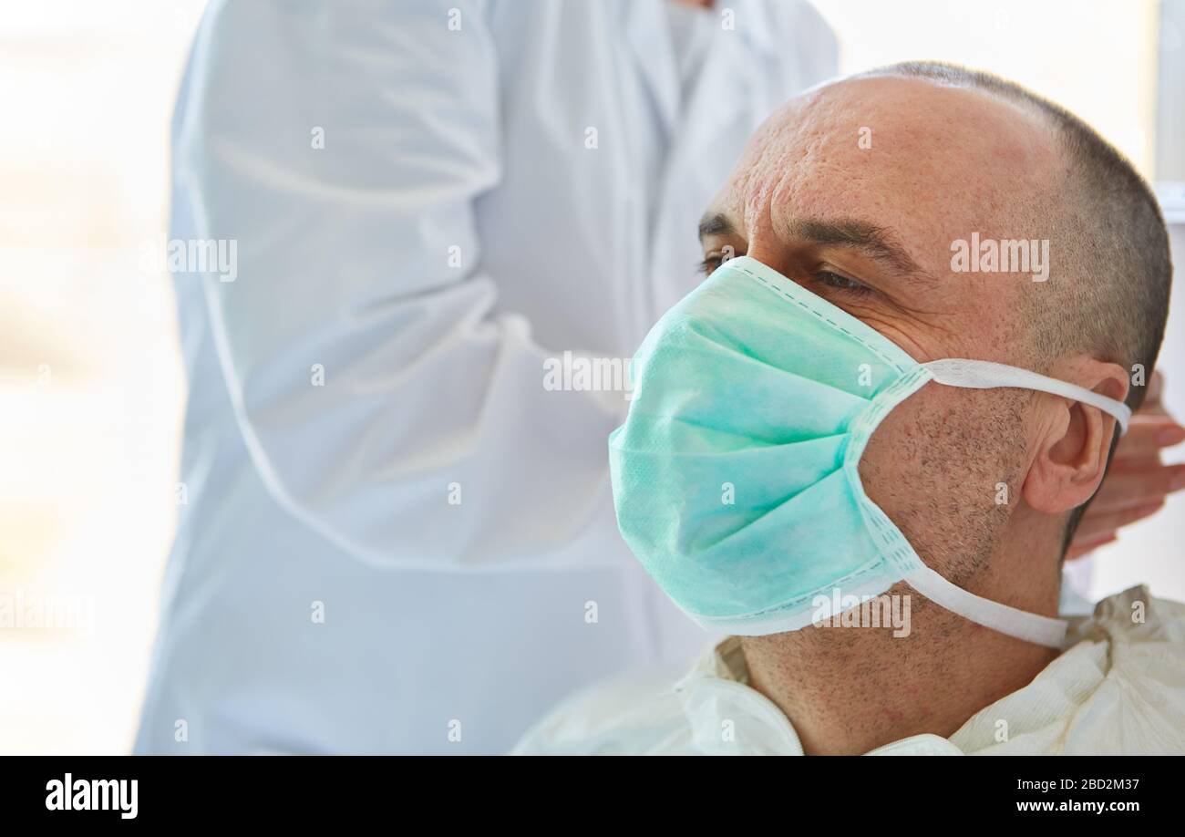 Doctor with face mask and protective clothing in intensive care clinic ...