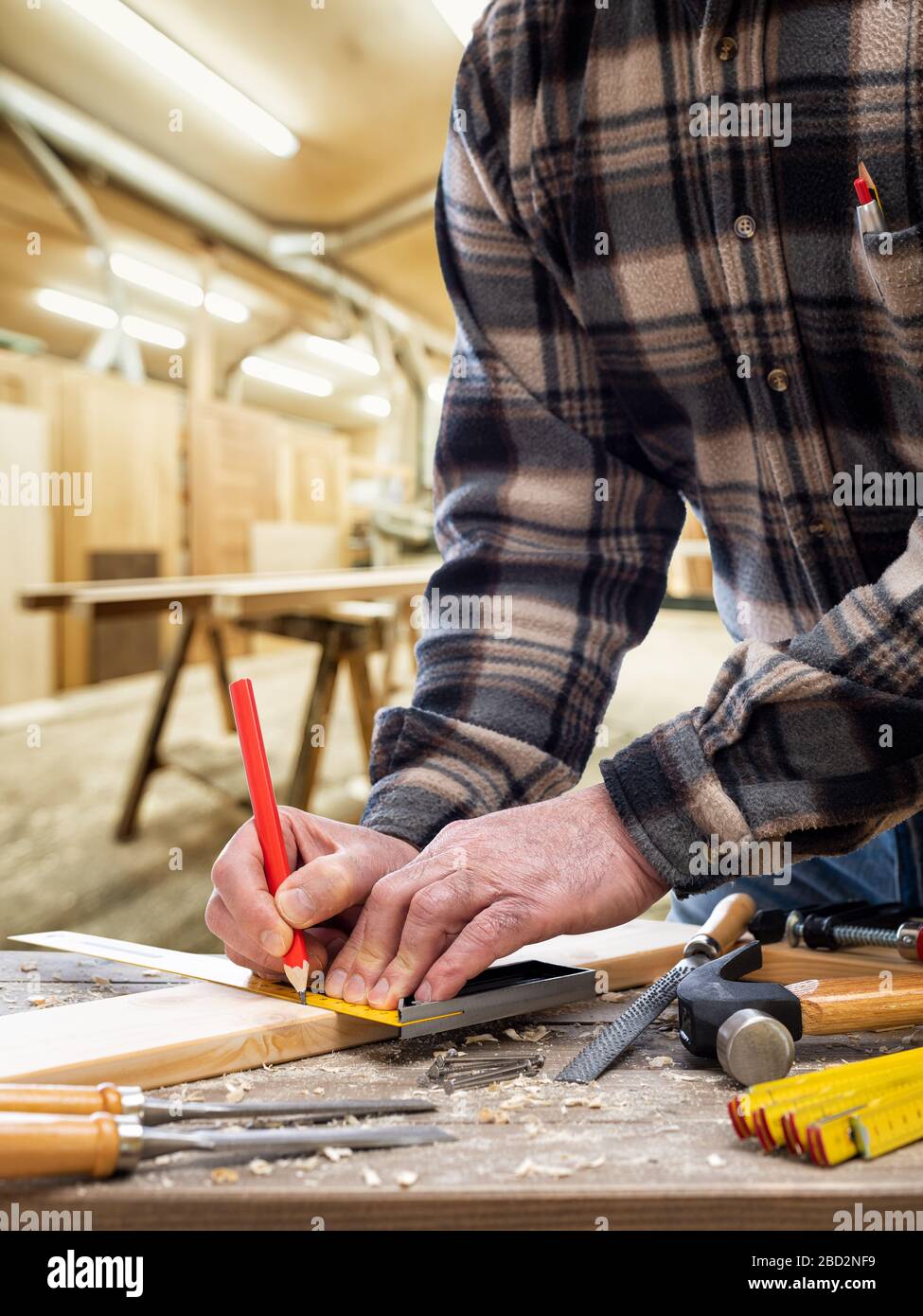 Close-up. Carpenter with pencil and carpenter's square draw the cutting ...