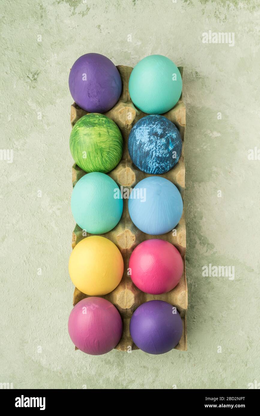 colorfully painted easter eggs on a green background with copy space ...