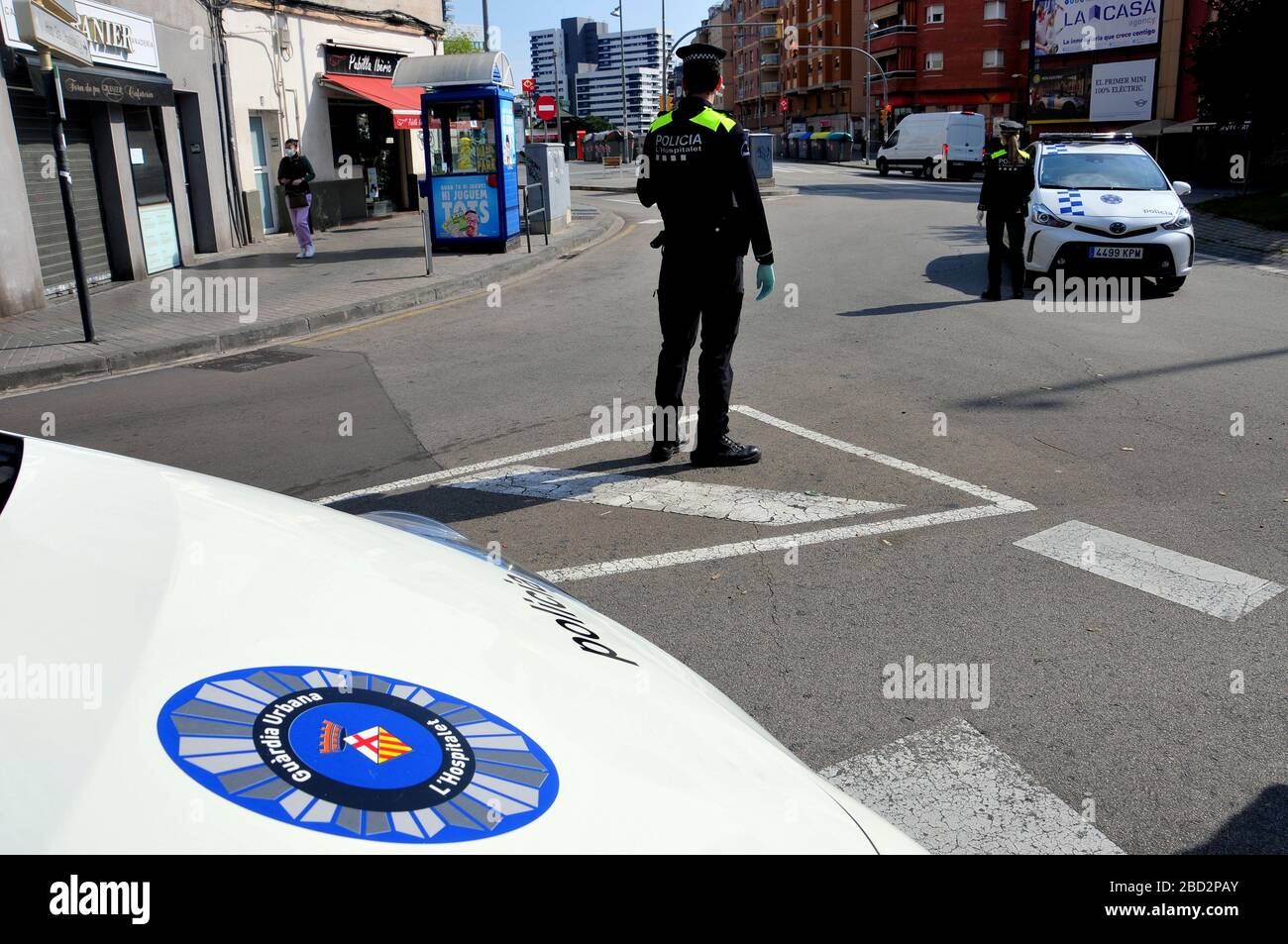 A police officer wearing a face mask and surgical gloves at a ...