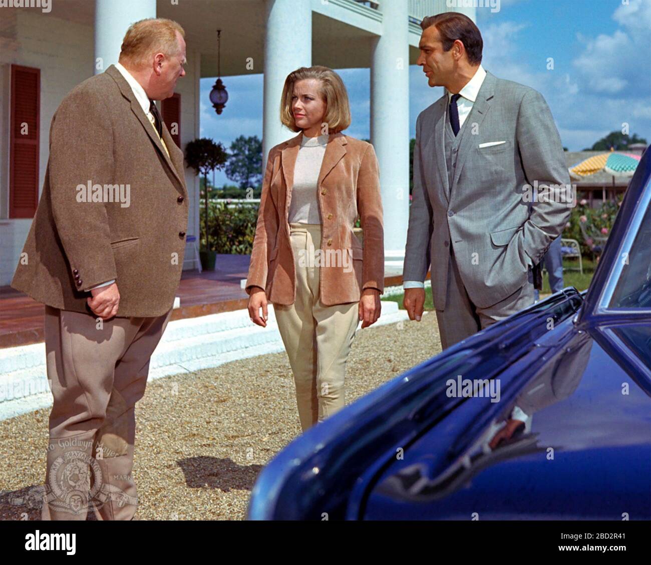 GOLDFINGER 1964 United Artists film with from left: Gert Frobe, Honor Blackman as Pussy Galore ...