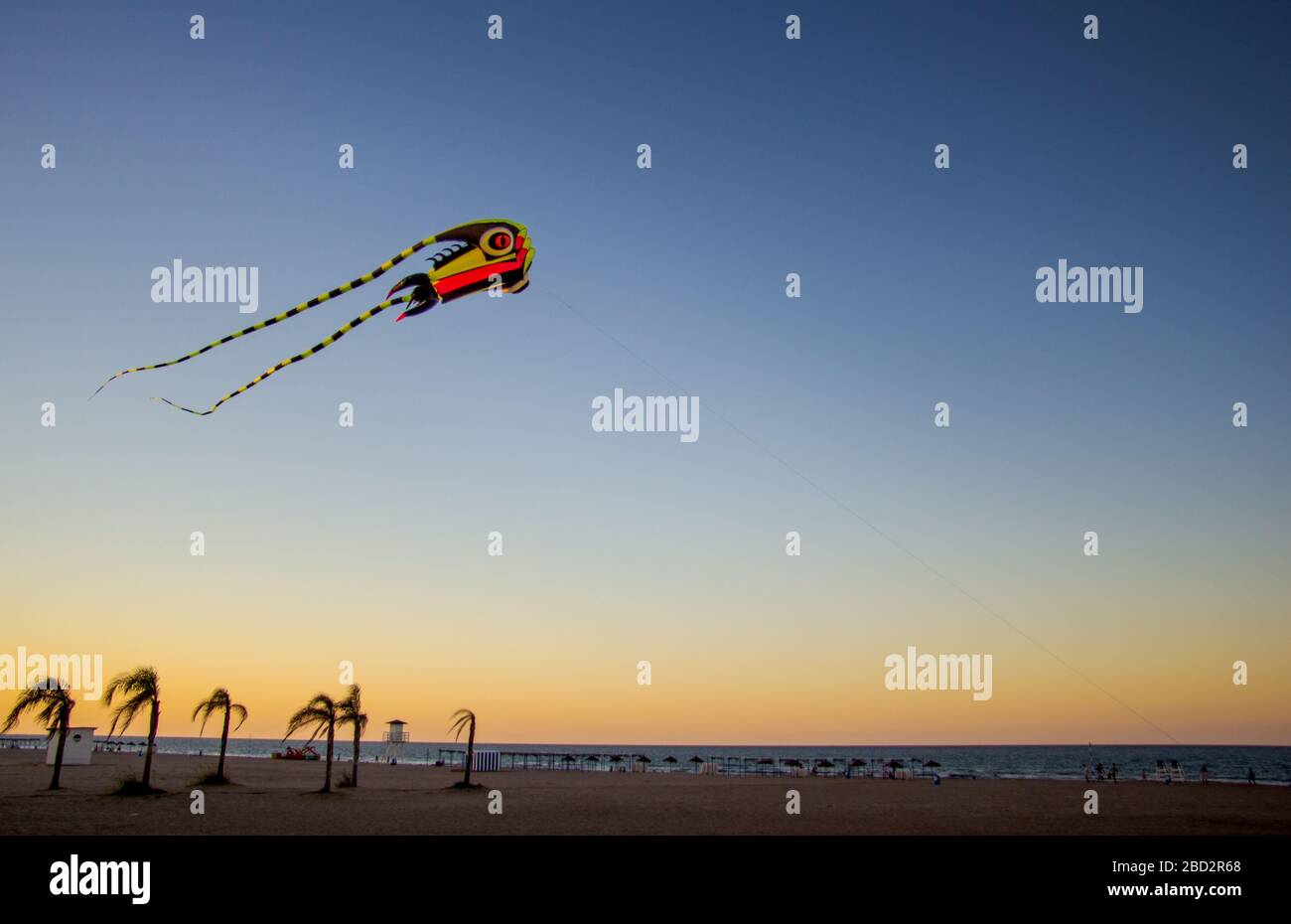 Strange kite on a beach during sunset Stock Photo - Alamy