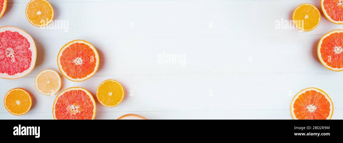 Different kinds of slice citrus fruits on white wooden background Stock ...