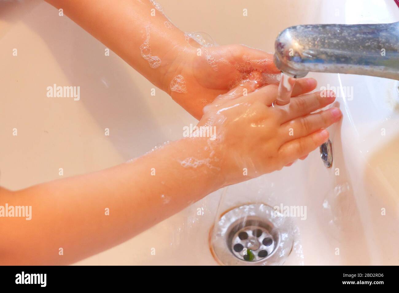 Washing hands with soap, child hands Stock Photo - Alamy