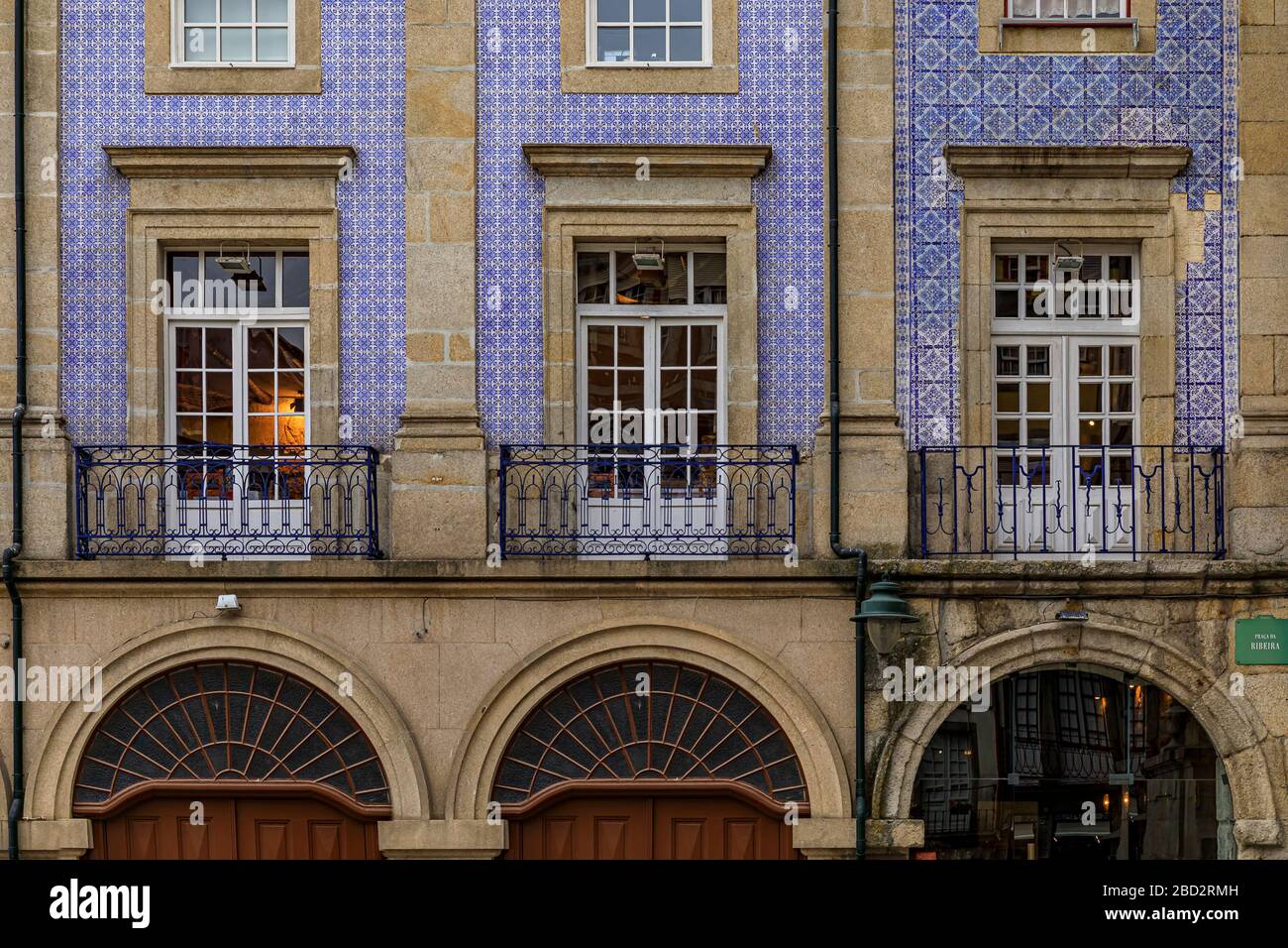 Facades of traditional houses decorated with ornate Portuguese azulejo ...