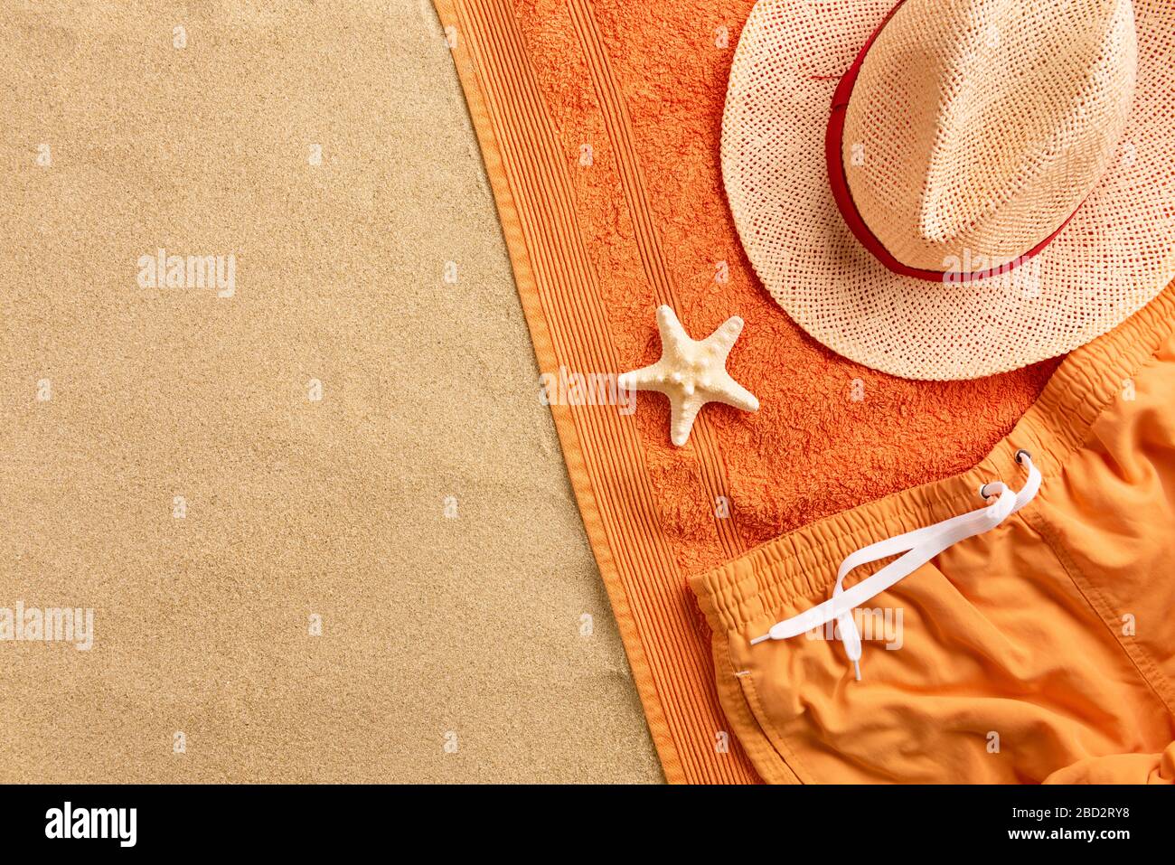 Top view of sandy beach with summer accessories. Background with copy ...